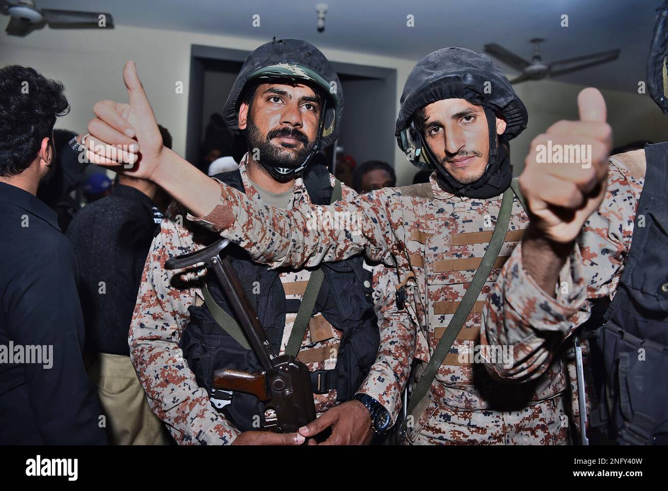Paramilitary soldiers gestures while they leave after conducting ...