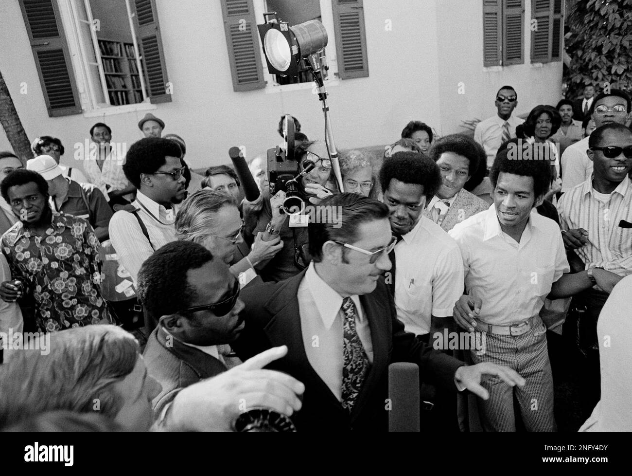 Robert Vesco is rushed through the crowd as he appears for an ...