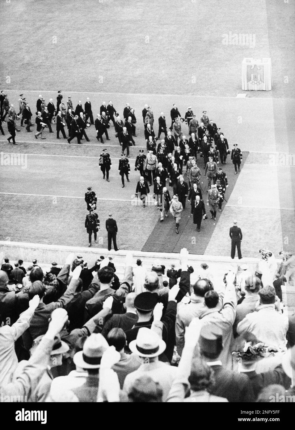 Fuehrer Adolf Hitler, in light suit, walks with a delegation as they ...
