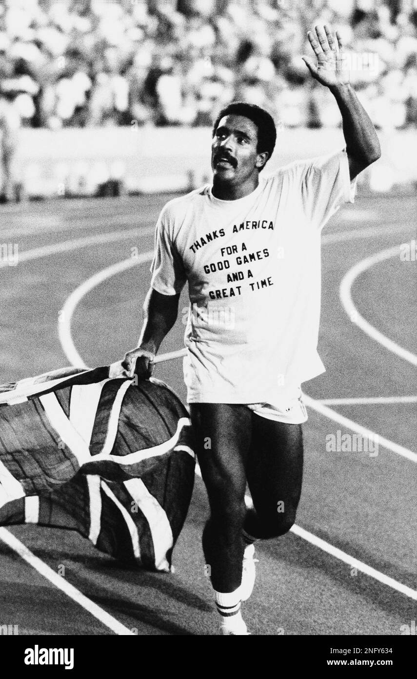 Great Britian's Daley Thompson waves to the crowd as he carries a Union ...