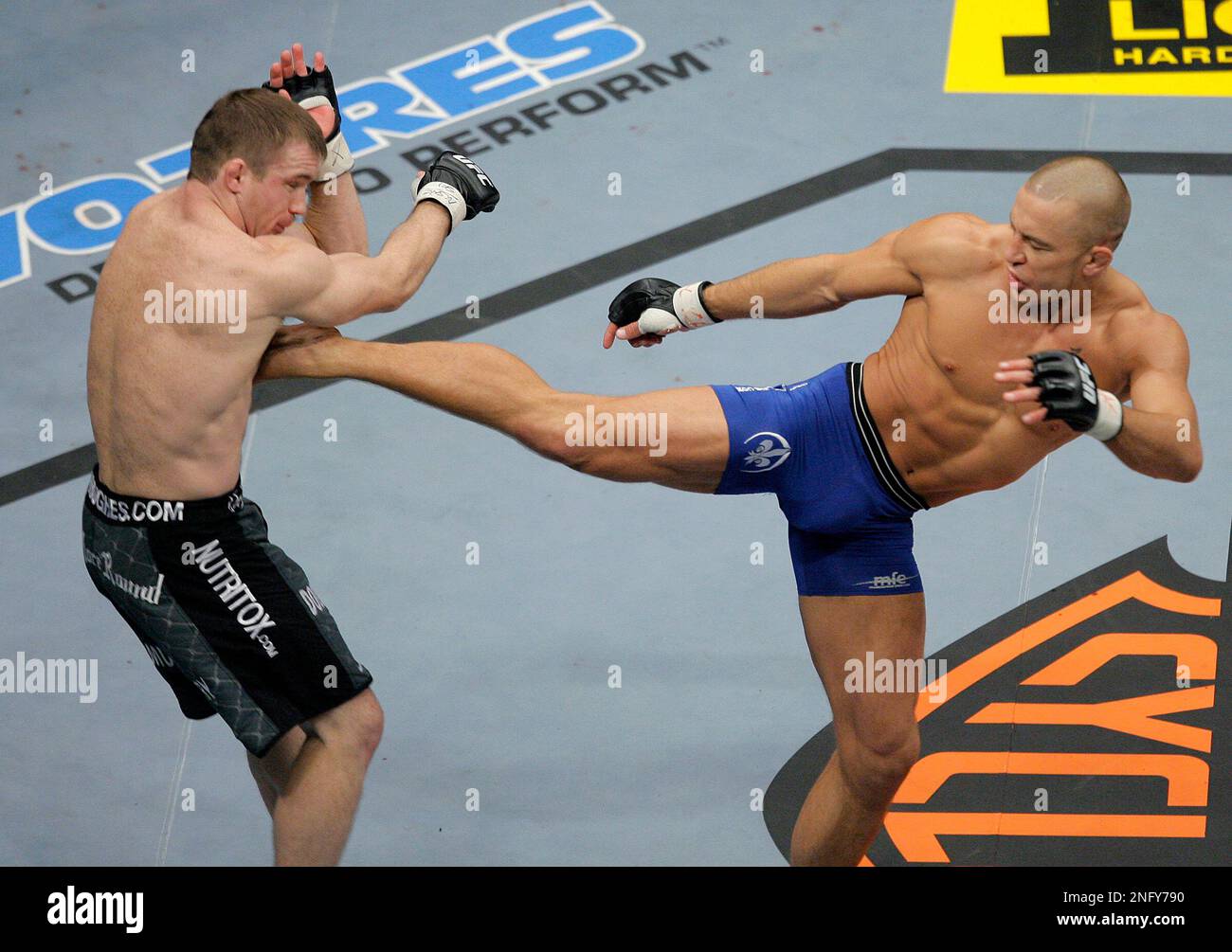 Georges St. Pierre, right, of Montreal, Canada, kicks Matt Hughes ...