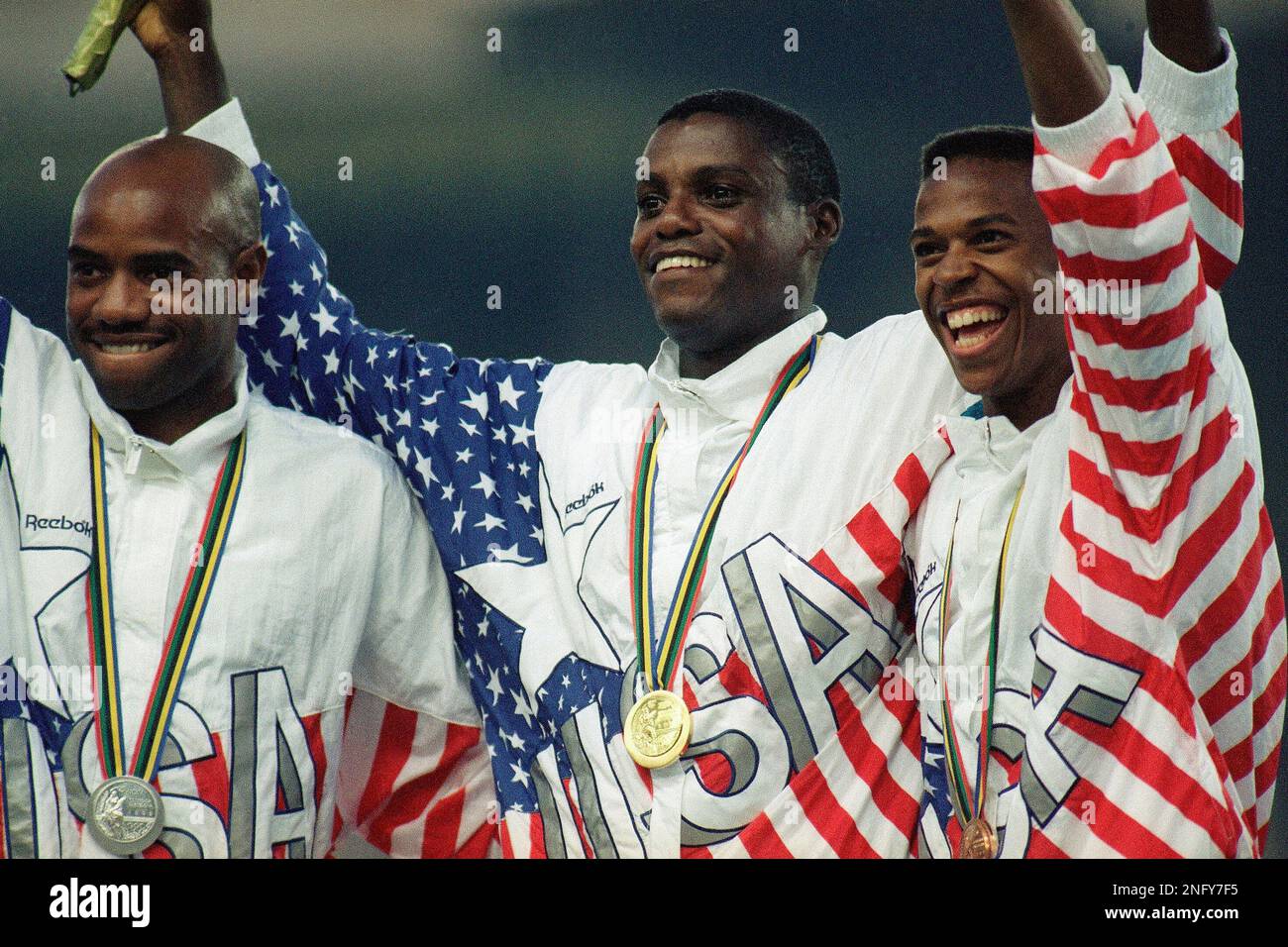 The USA's Carl Lewis, center, Houston. Tex., Mike Powell, left, Alta Loma, Calif., and Joe ...