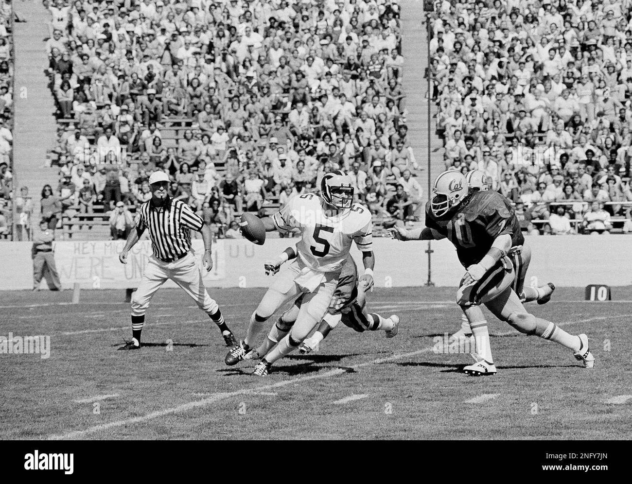 University of Michigan quarterback John Wangler is sacked by Daryle ...