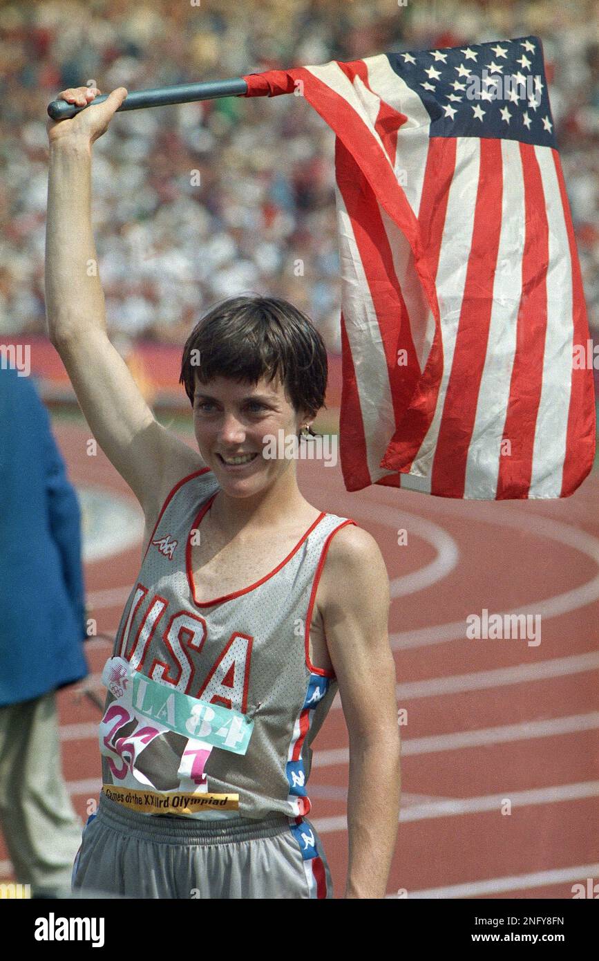 U.S. runner Joan Benoit of Freeport, Maine, waves the American flag on ...