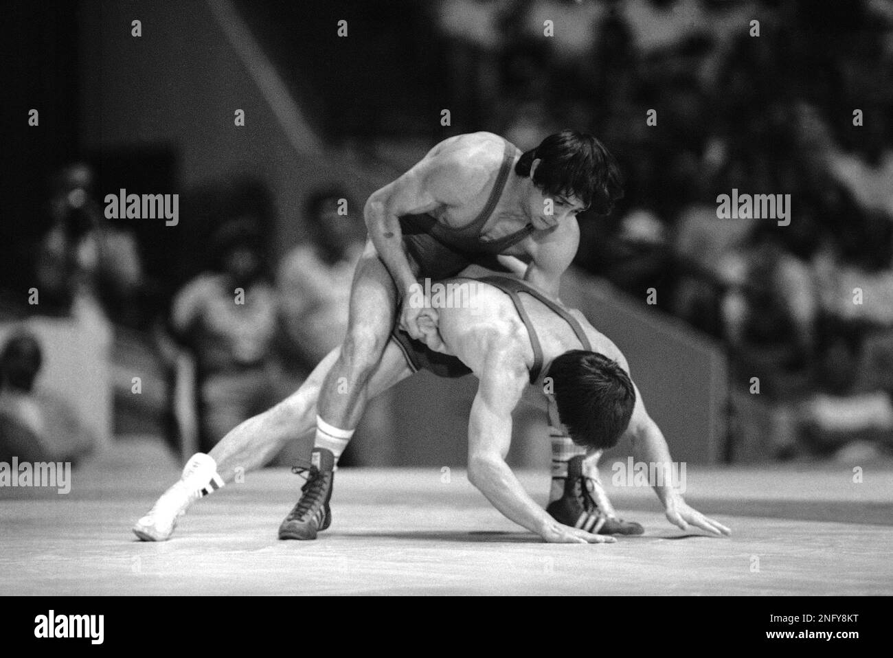 Italy's Vincezo Maenza is locking West Germany's Markus Schere in the ...