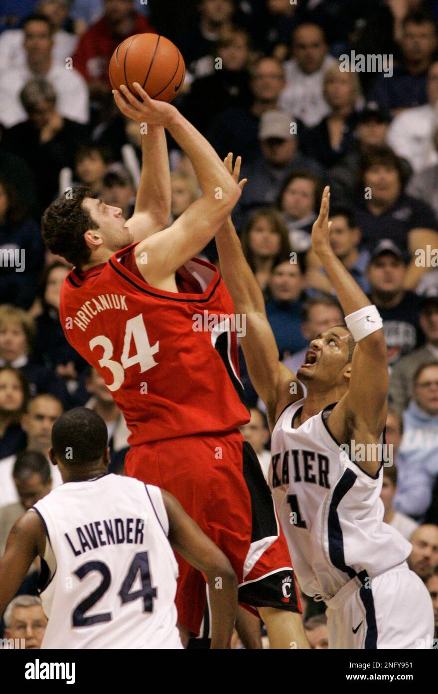 Cincinnati center Adam Hrycaniuk (34), from Poland, shoots over Xavier ...