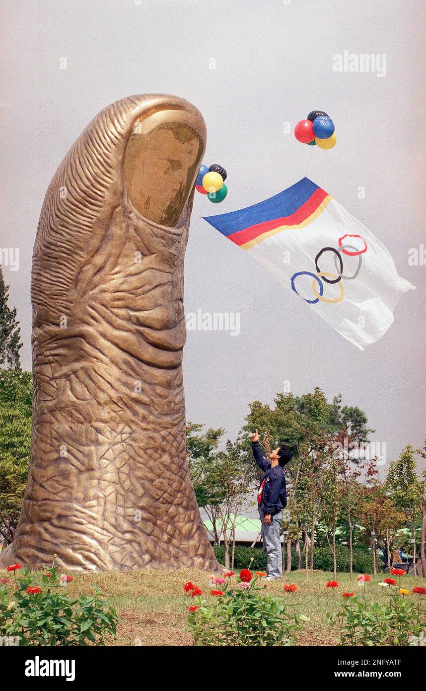 This golden painted sculpture featuring a huge thumb and designed by ...