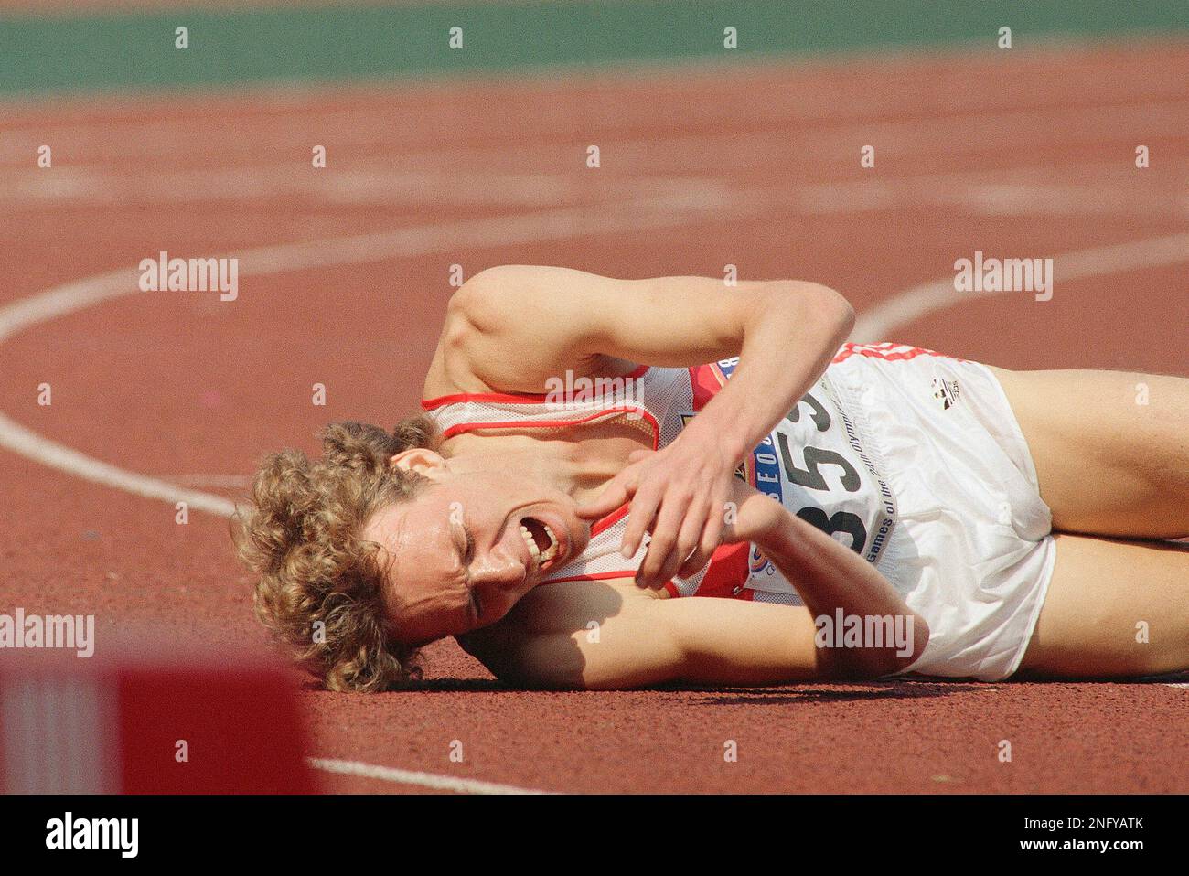West German Dieter Baumann collapses on the track after sprinting to ...