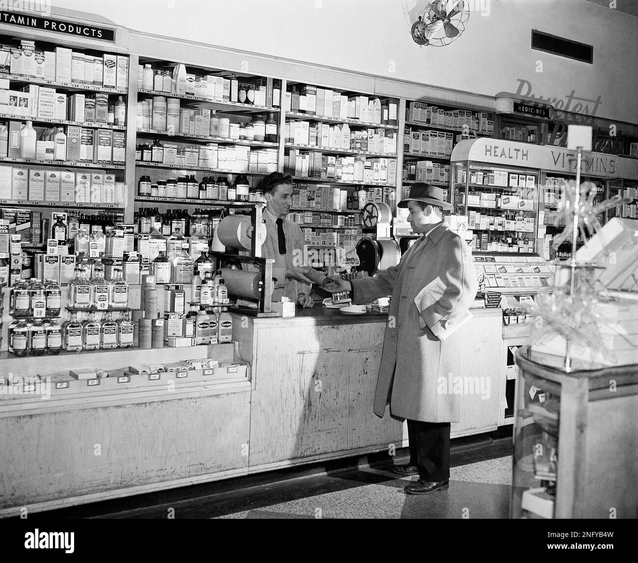 A man is helped at a vitamin counter at the Liggett Drug store located ...
