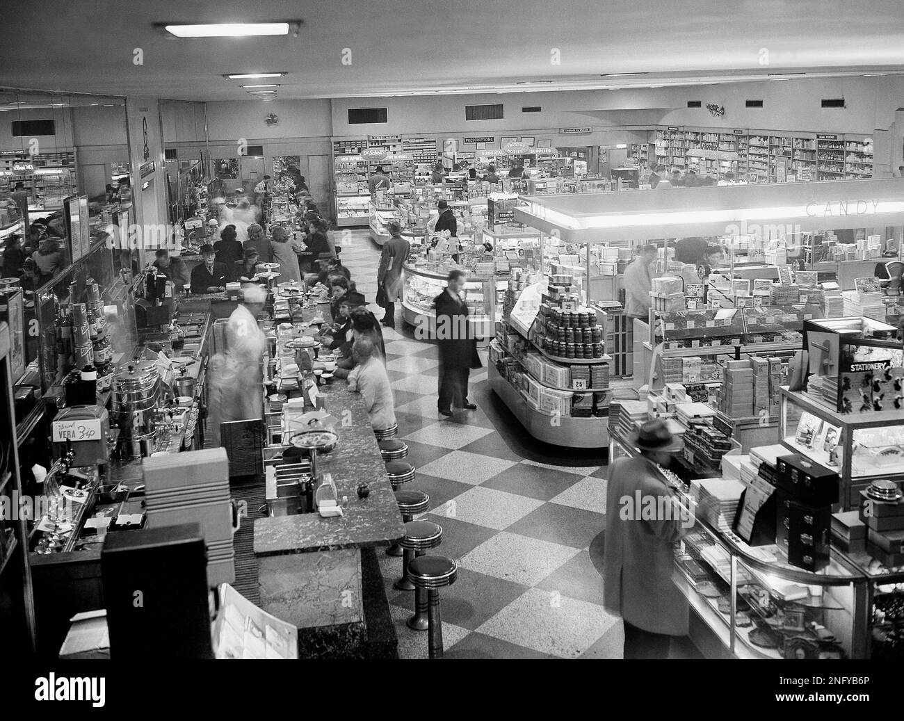 Shoppers look over cosmetics; health products and rest at a coffee ...