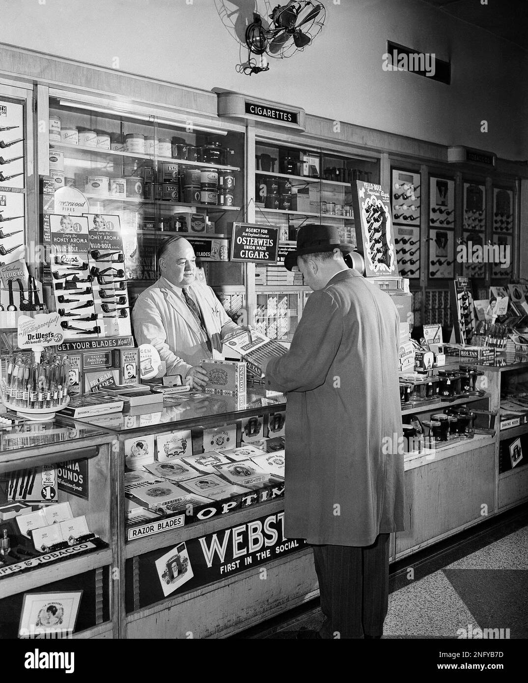 A customer shops at the tabacco counter at the Liggett Drug Store ...