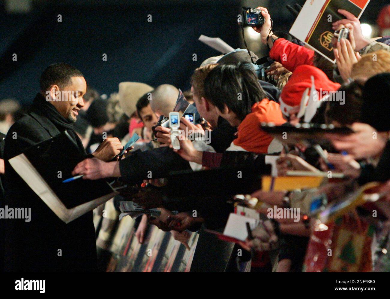 U.S. actor Will Smith signs autographs for fans as he arrives for the ...