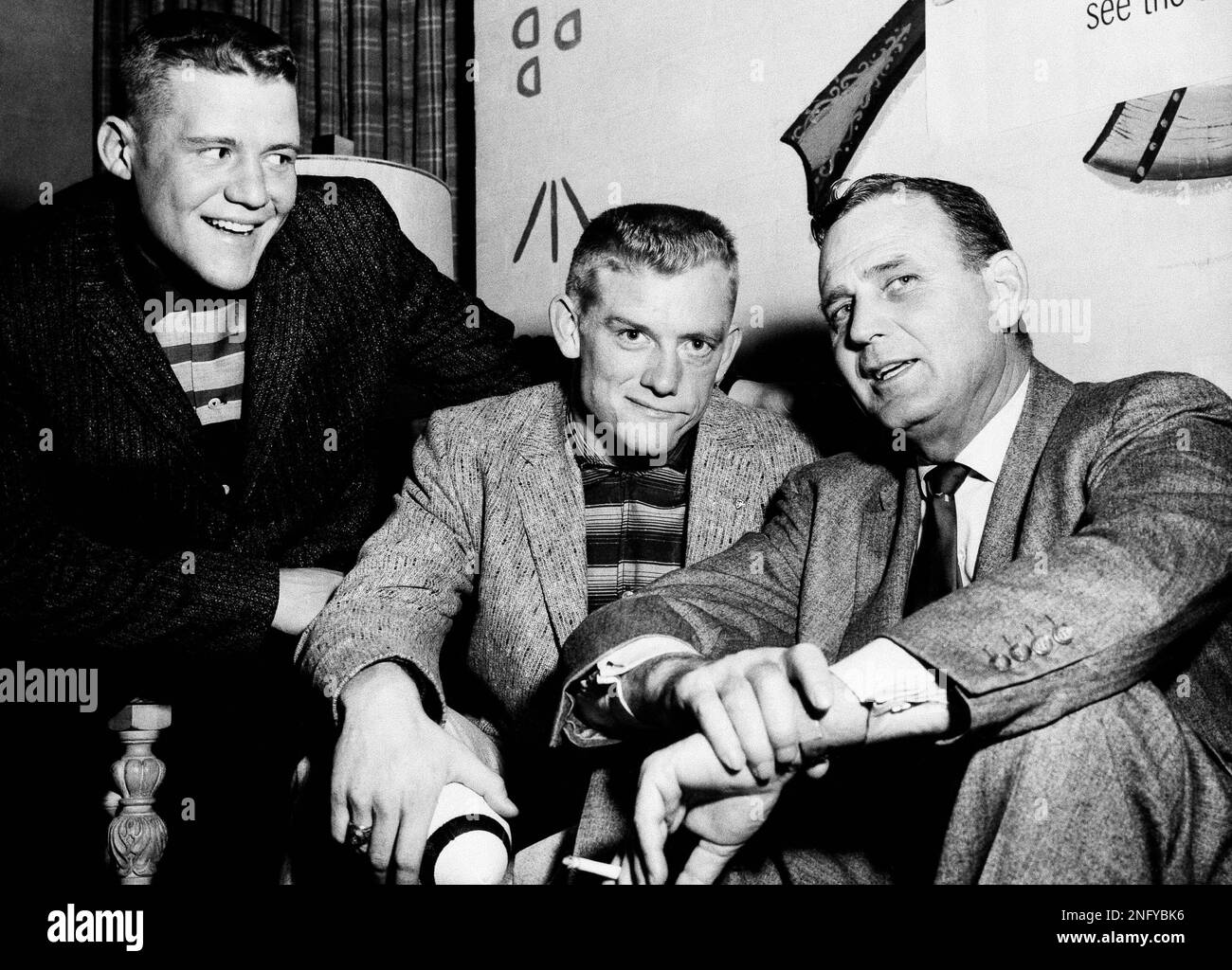 Charlie Krueger, left, and John Crow, center, pose with their coach ...