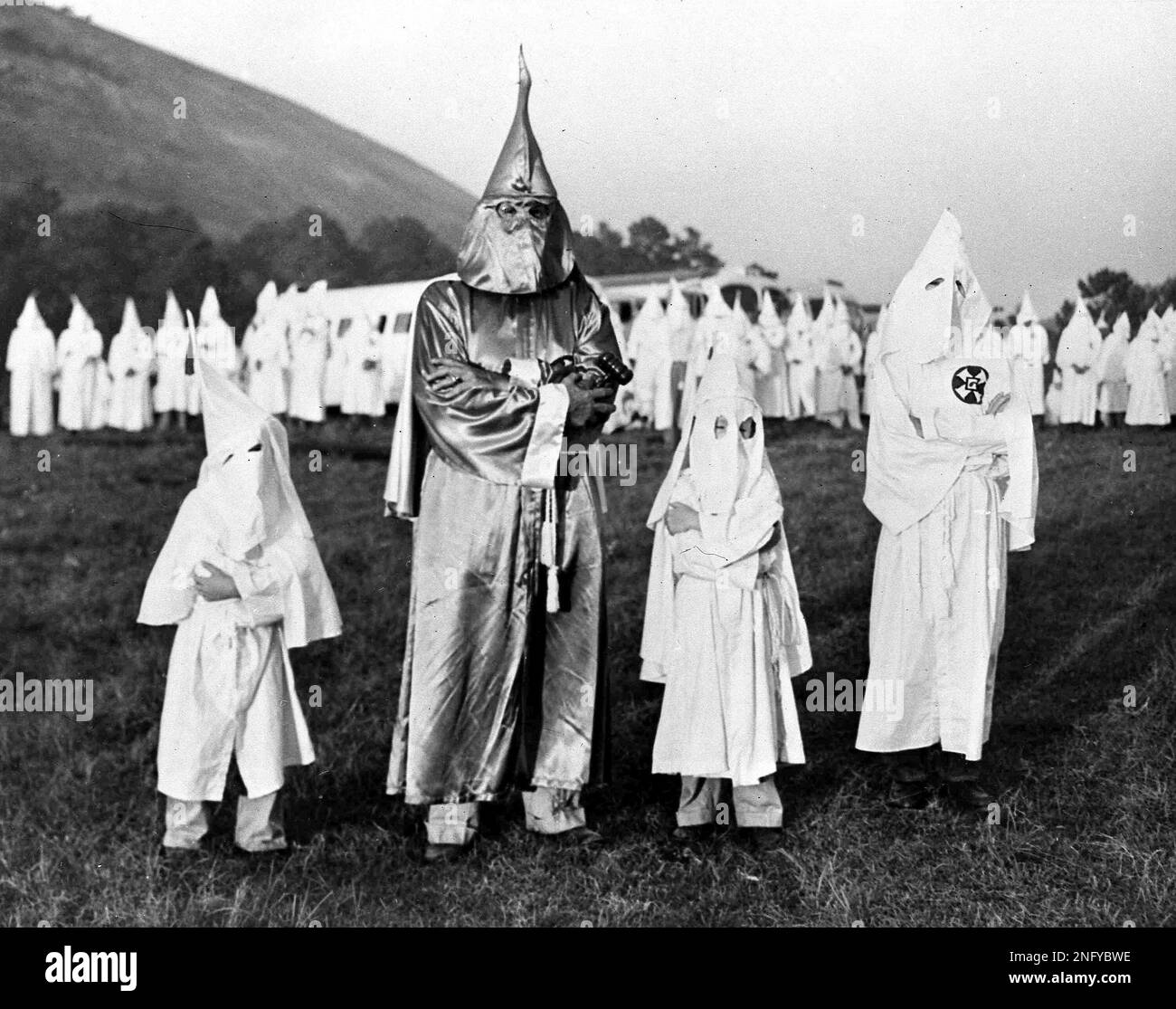 Two little mascots, equipped with their own robes and hoods, flank Dr ...