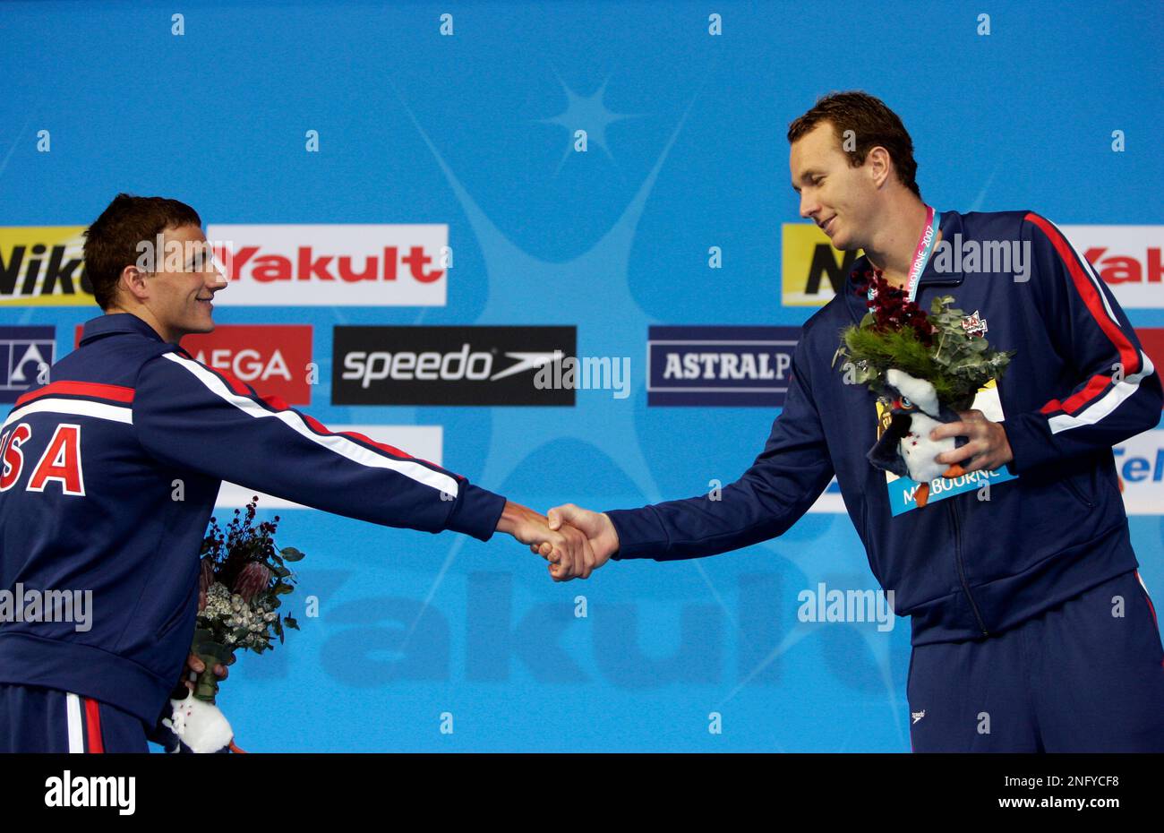 Aaron Peirsol of the USA, right, shakes hands with compatriot Ryan ...