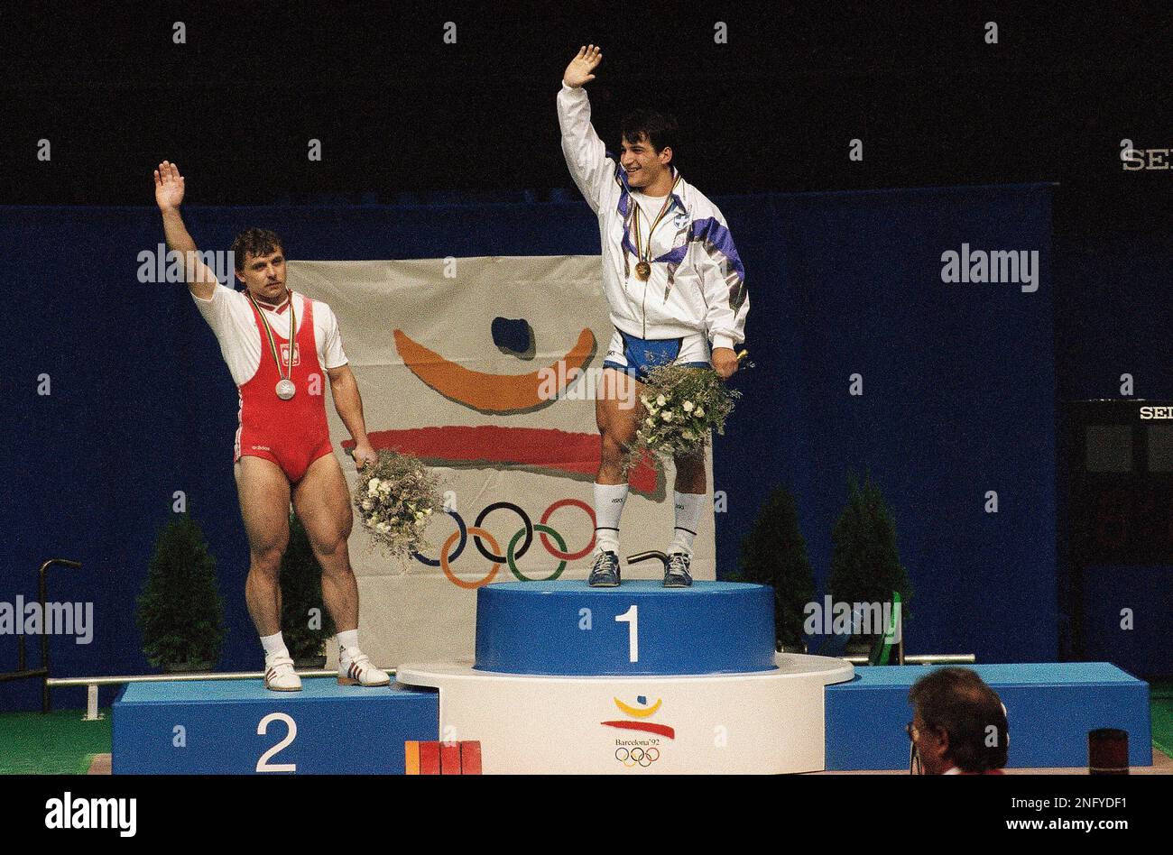 Greece's Pyrros Dimas, center stand, and Poland's Krzysztof Siemion ...