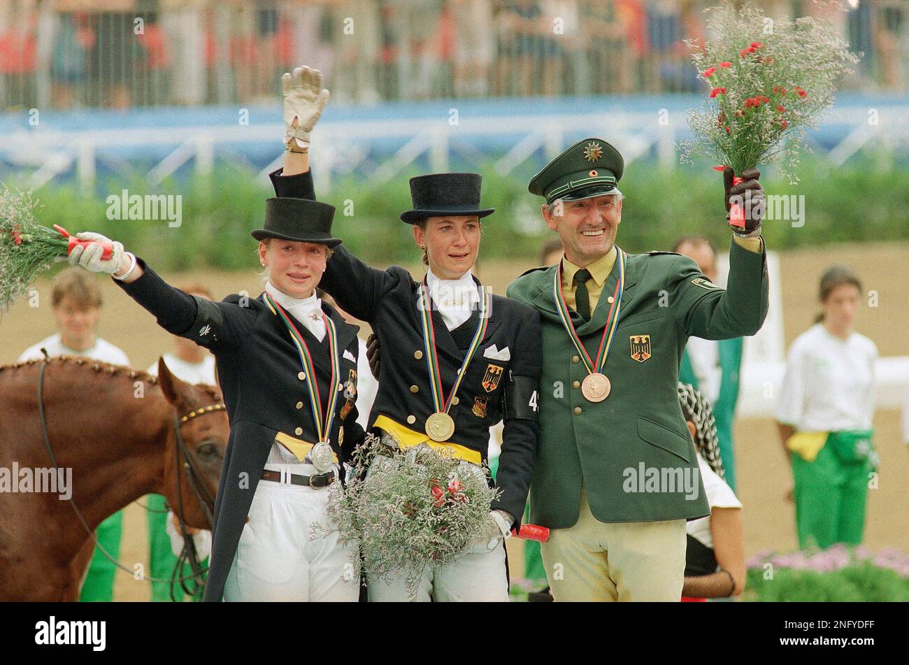 Members of Germany's dressage team acknowledge the crowd after sweeping ...