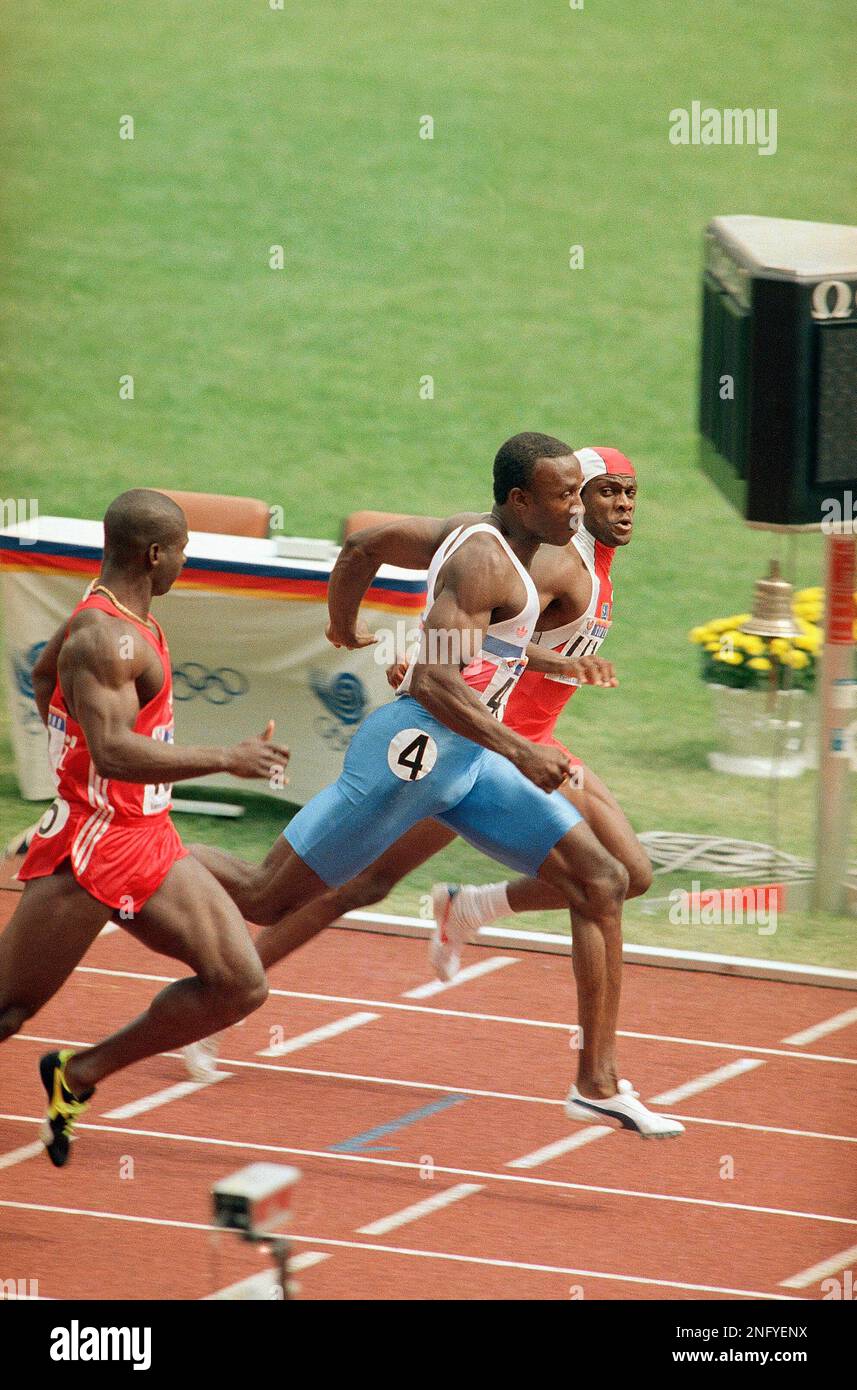 Canada's Ben Johnson, left, watches Great Britain's Linford Christie ...