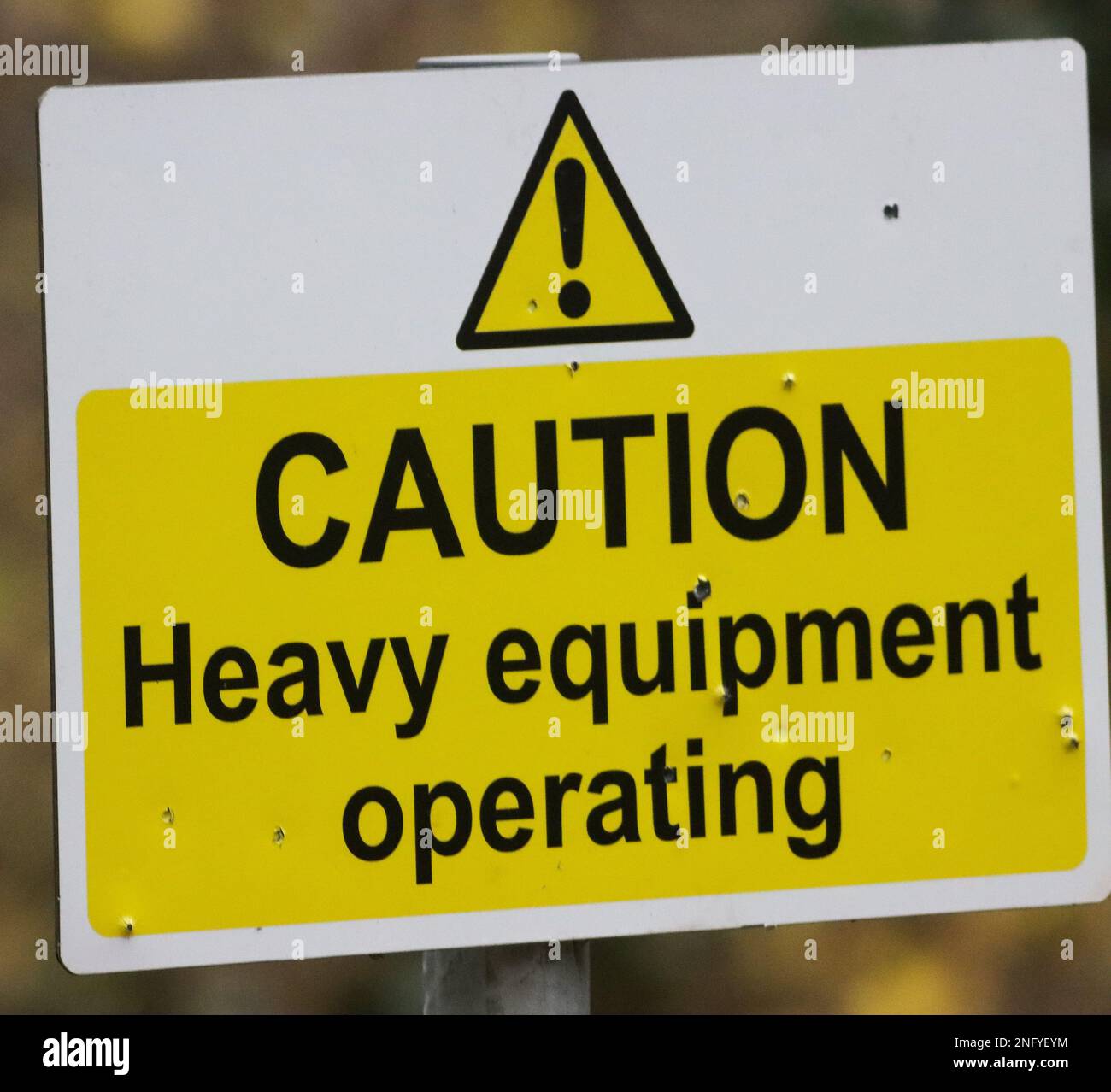A caution heavy equipment operating sign Stock Photo - Alamy