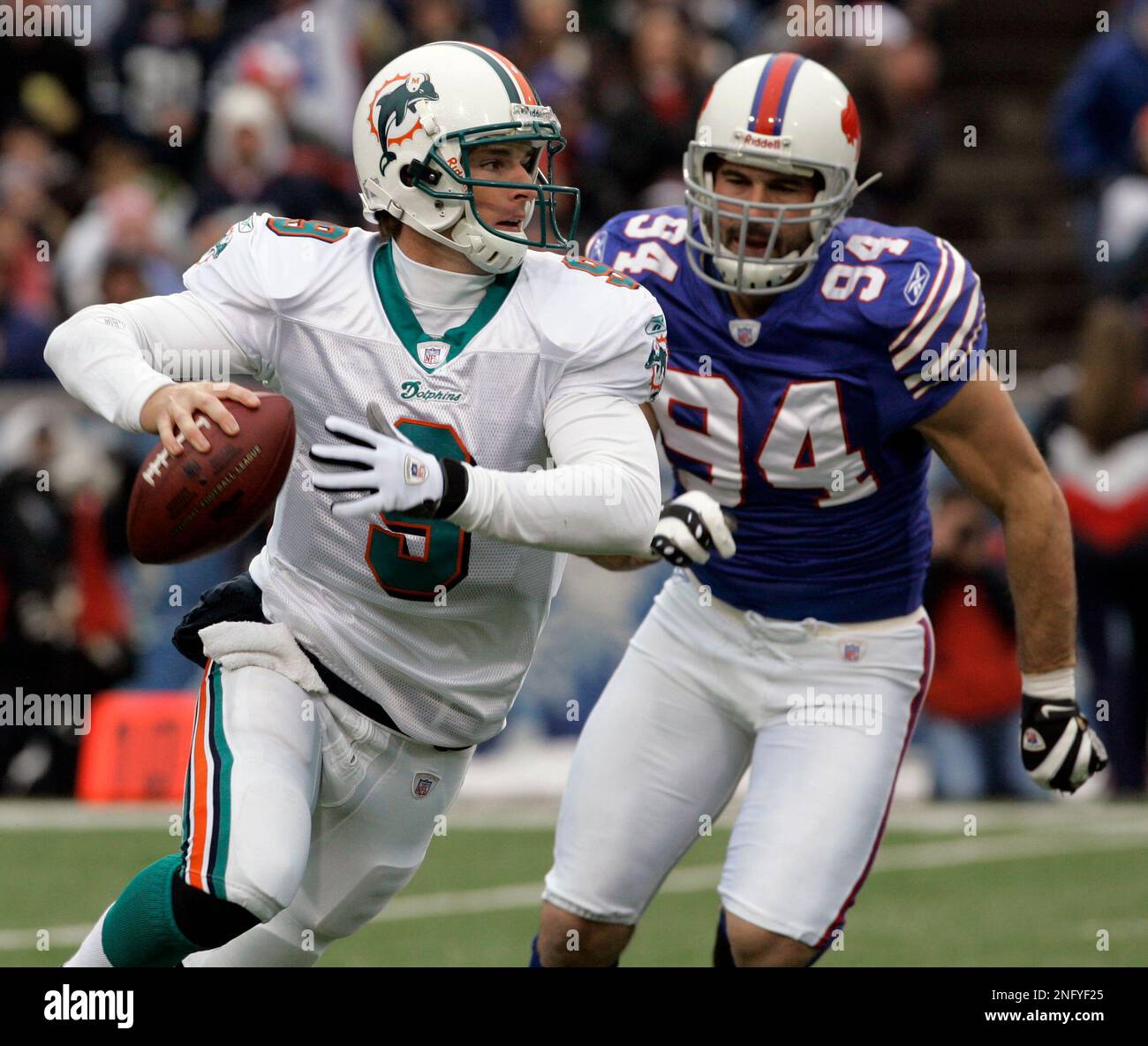 Miami Dolphins quarterback John Beck looks to throw under pressure from ...