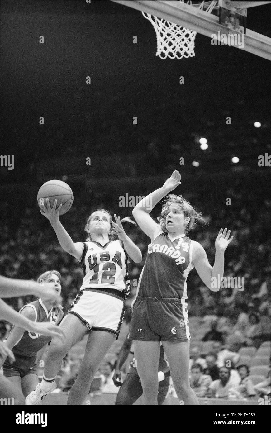 Canada's Misty Thomas (15), left, watches U.S.A.'s Kim Mulkey (12) of ...