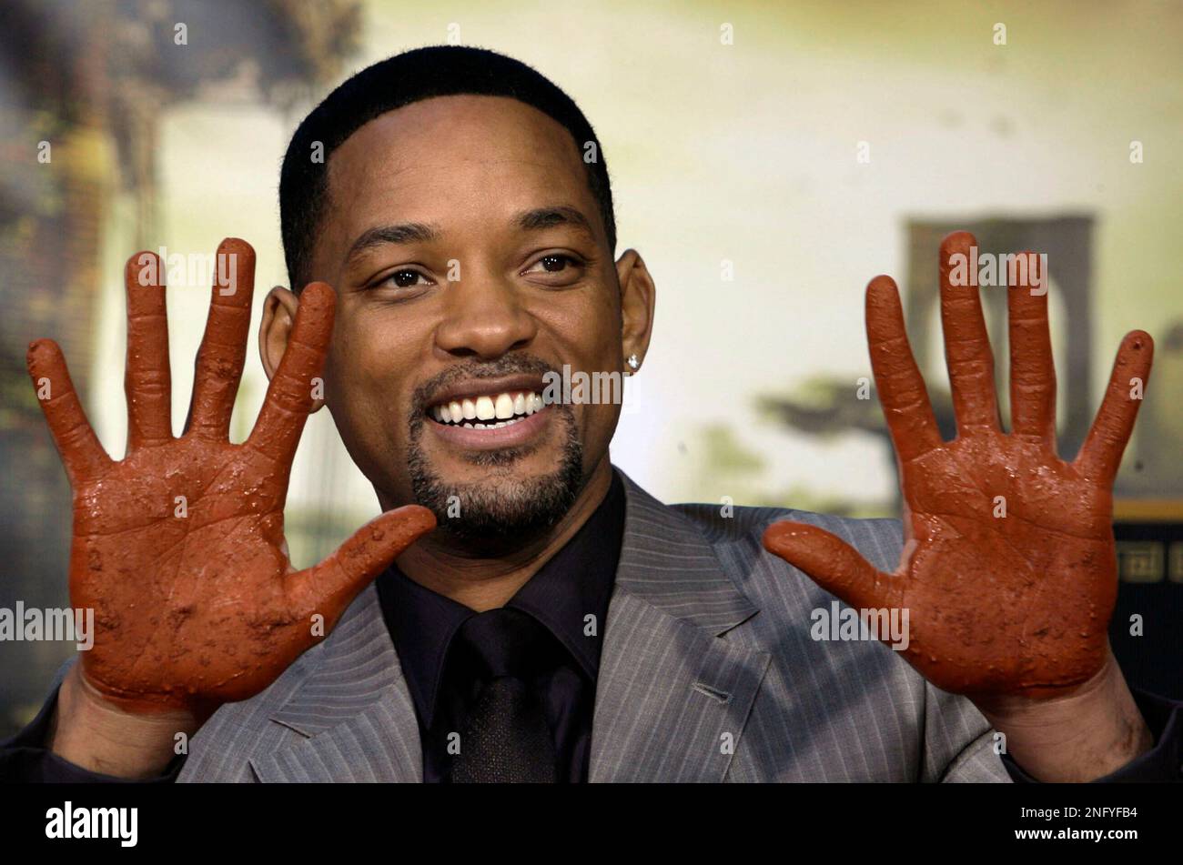 Actor Will Smith, star of "I Am Legend," shows his hands after placing ...