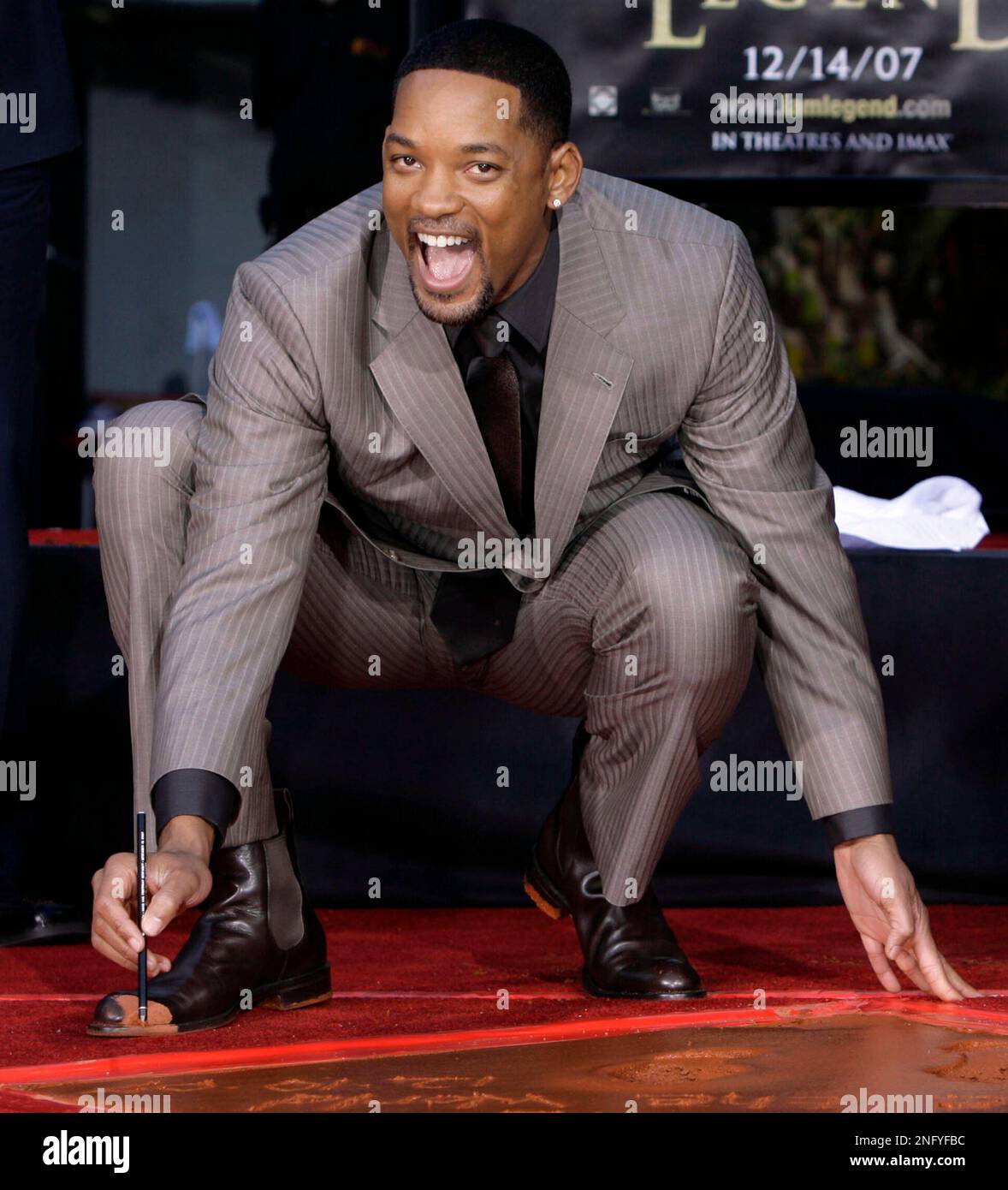 Actor Will Smith, star of "I Am Legend," signs his name in cement ...
