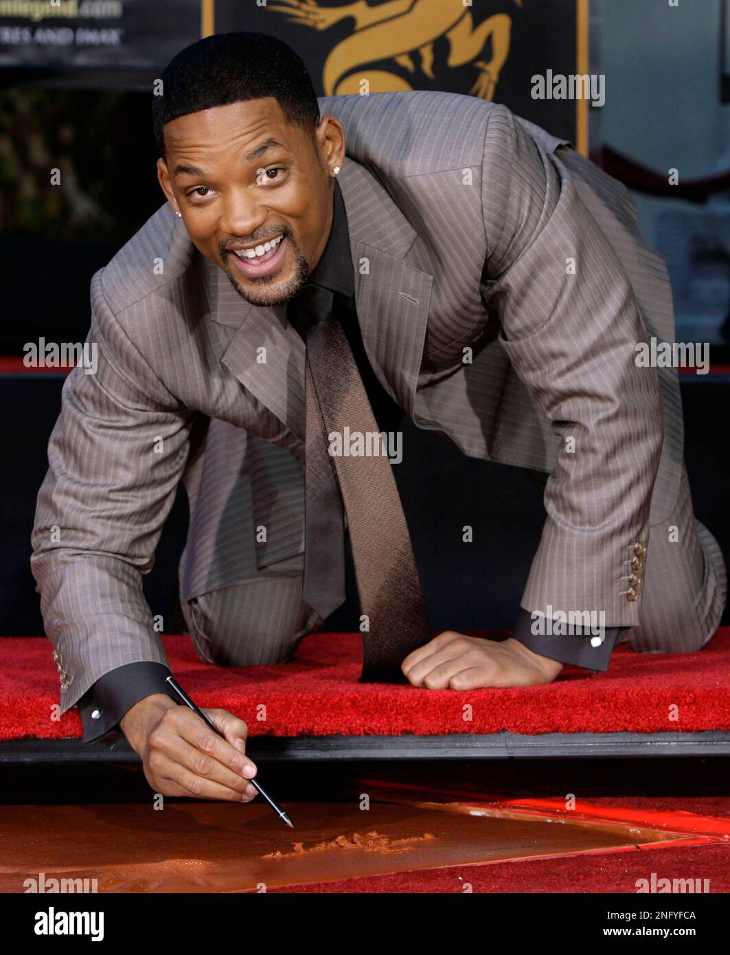 Actor Will Smith, star of "I Am Legend," signs his name in cement ...