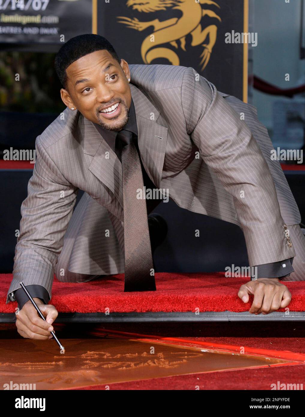 Actor Will Smith, star of "I Am Legend," signs his name in cement ...