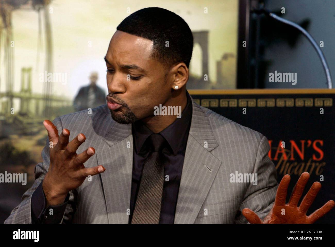 Actor Will Smith, star of "I Am Legend," looks at his hand after ...