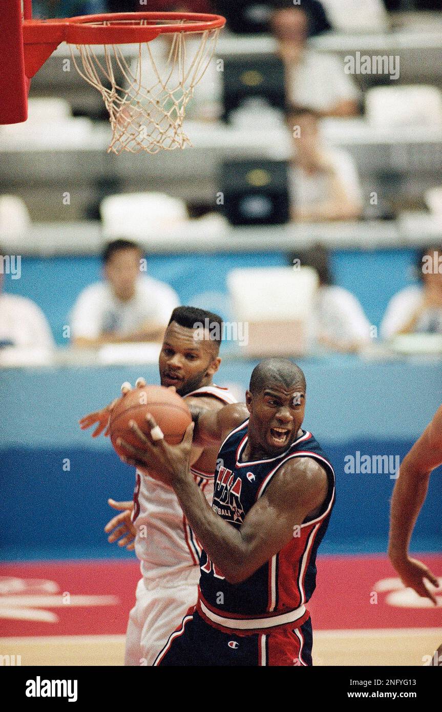 The USA's Earvin "Magic" Johnson rips a rebound away from Puerto Rico's ...