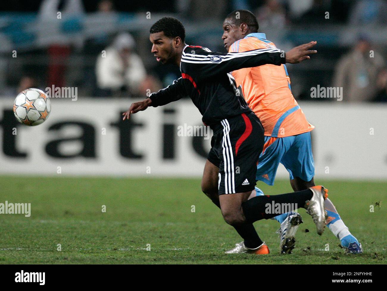 Marseille player Jacques Faty, right , challenges for the ball with ...