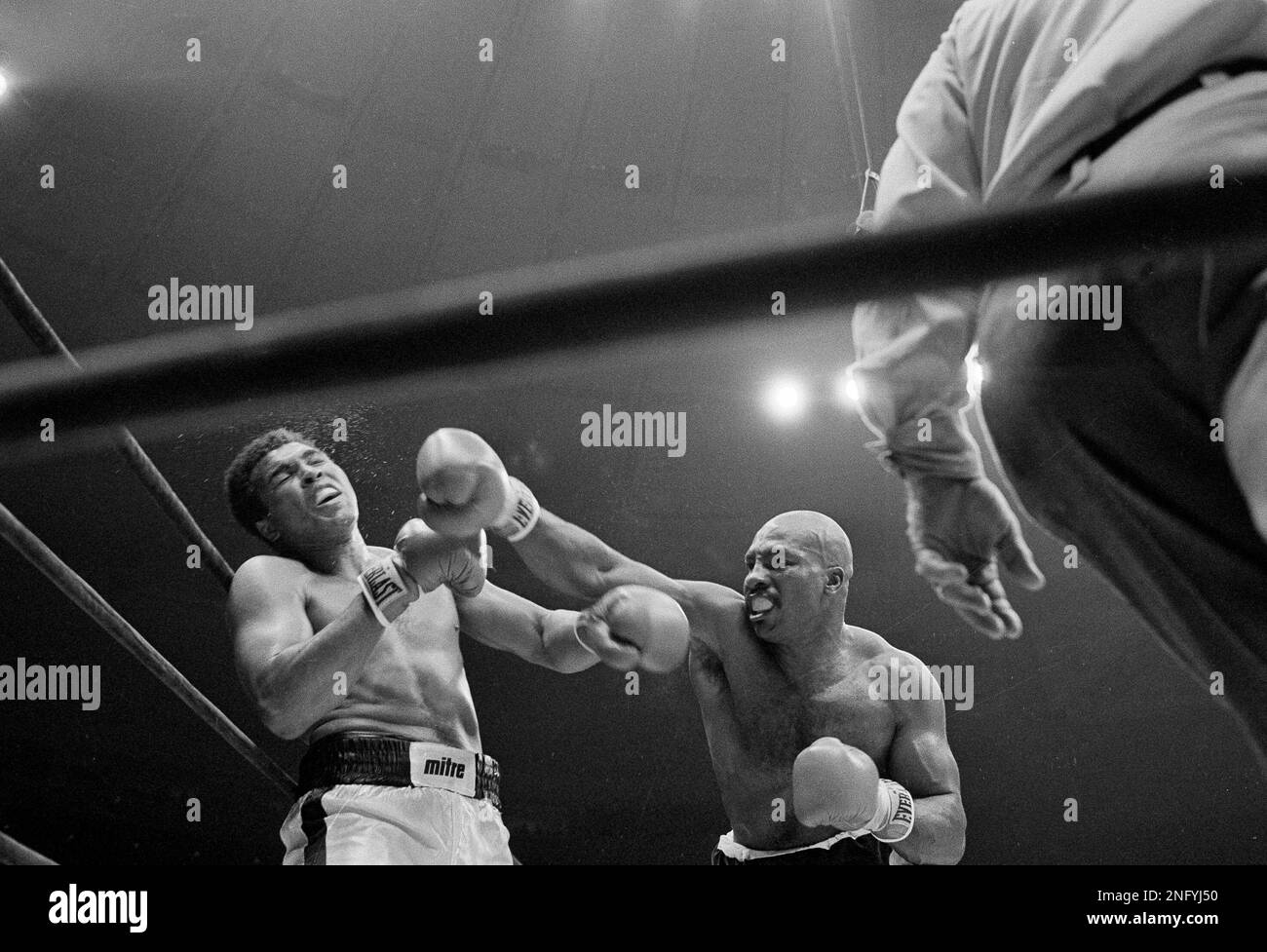 Challenger Earnie Shavers, right, follows through with a right against ...
