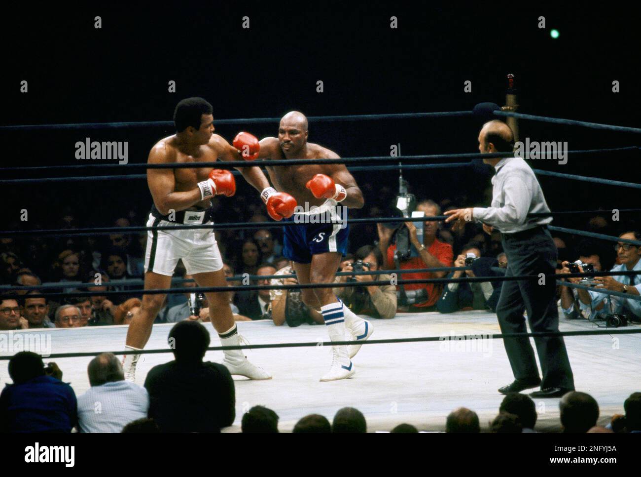Heavyweight boxing champ Muhammad Ali, left, defends his title in his ...