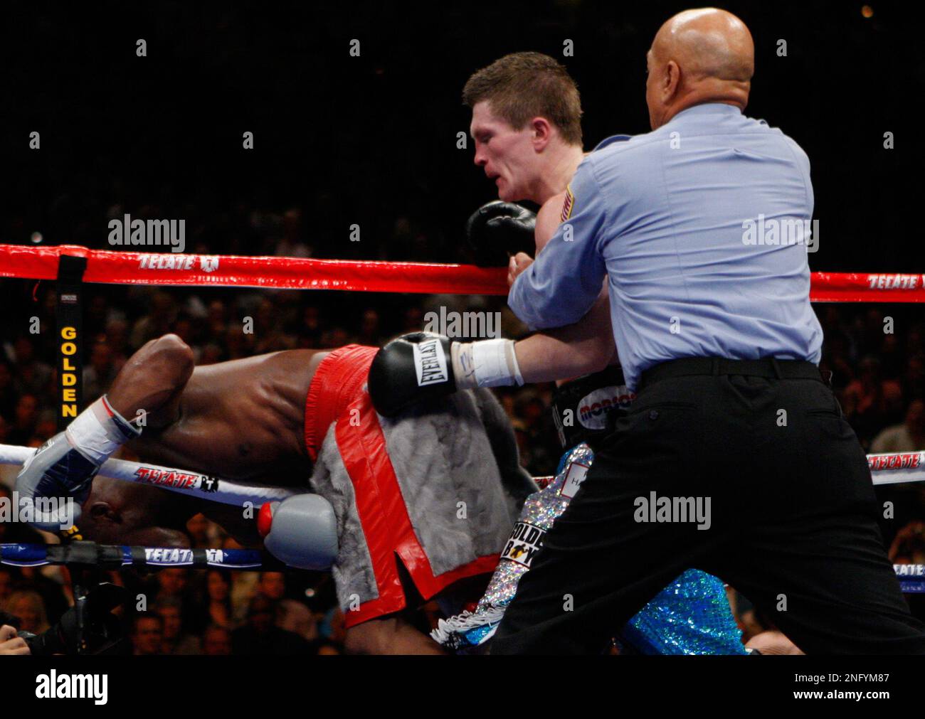 Ricky Hatton, of Great Britain, center, is held back from referee Joe ...