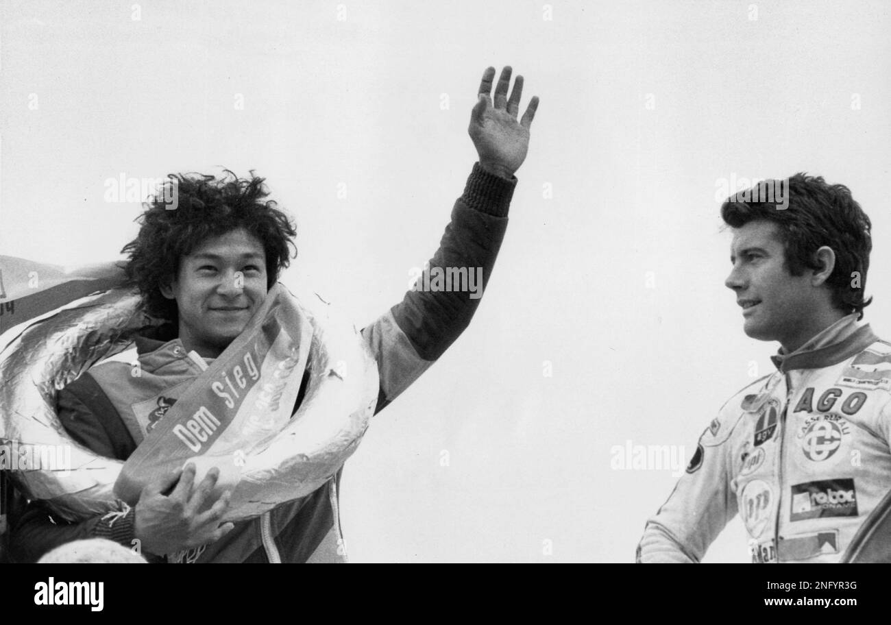 Japanese racer Takazumi Katayama, left, waves to the cheering crowd ...
