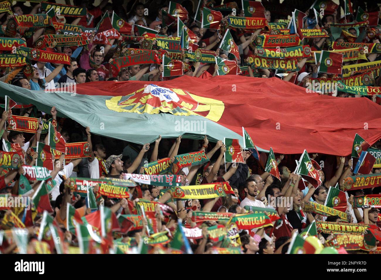 Portugal's supporters hold a national flag at the start of their ...