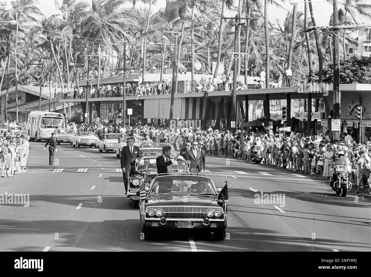 President John Kennedy waves to some of the thousands of persons who ...