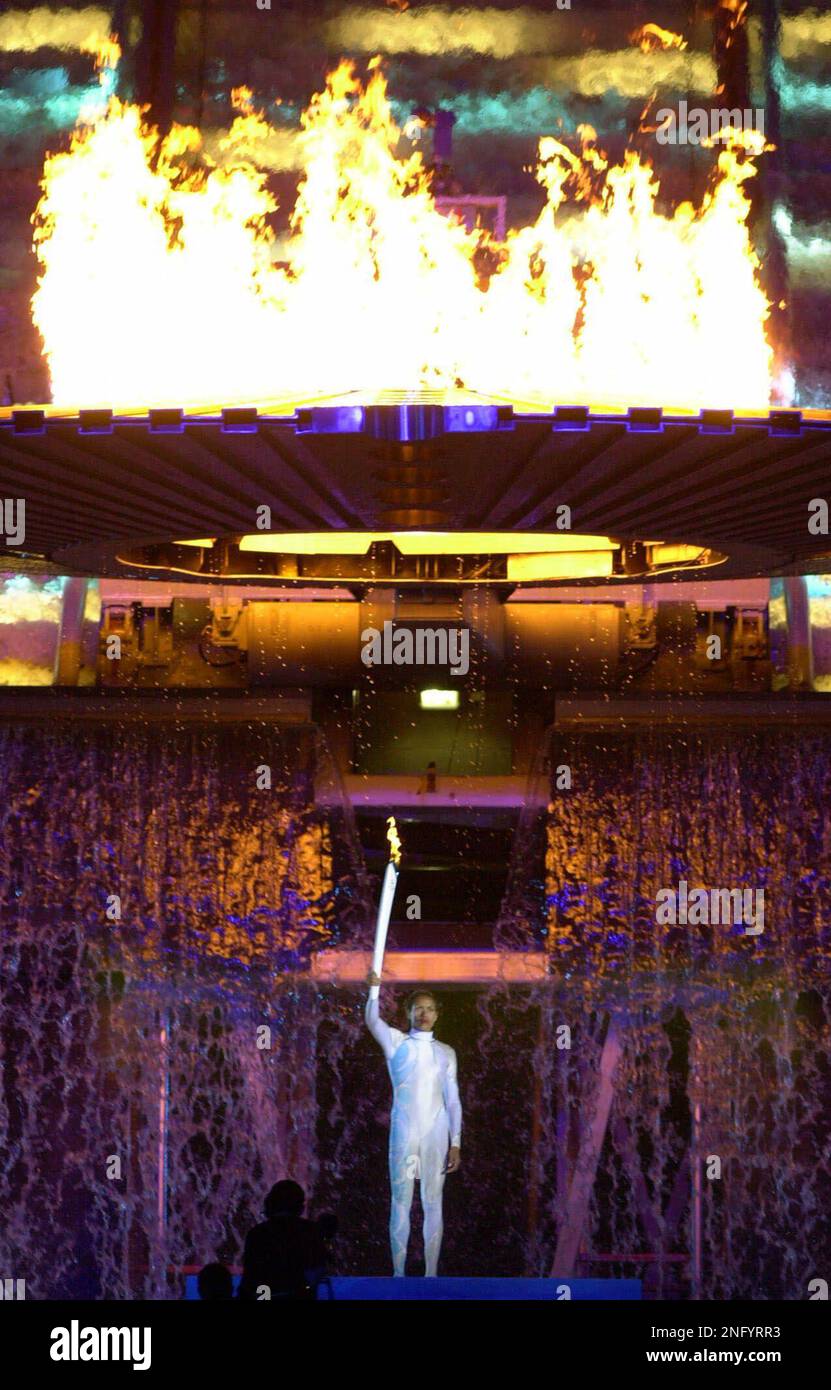 Australian runner Cathy Freeman, of aboriginal descent, holds the ...