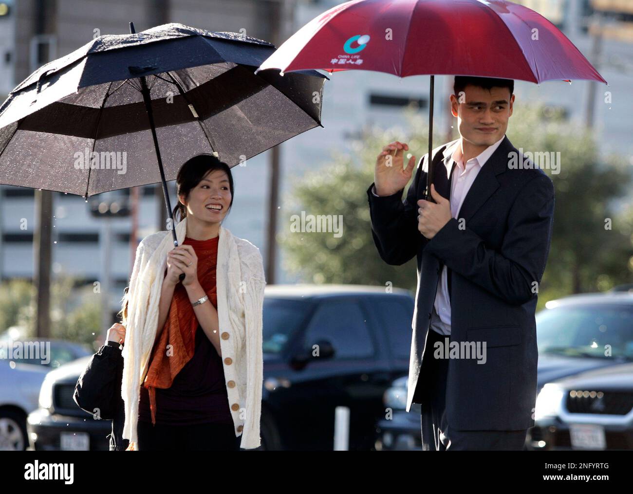 Houston Rockets basketball player Yao Ming, right, and his wife Ye Li ...