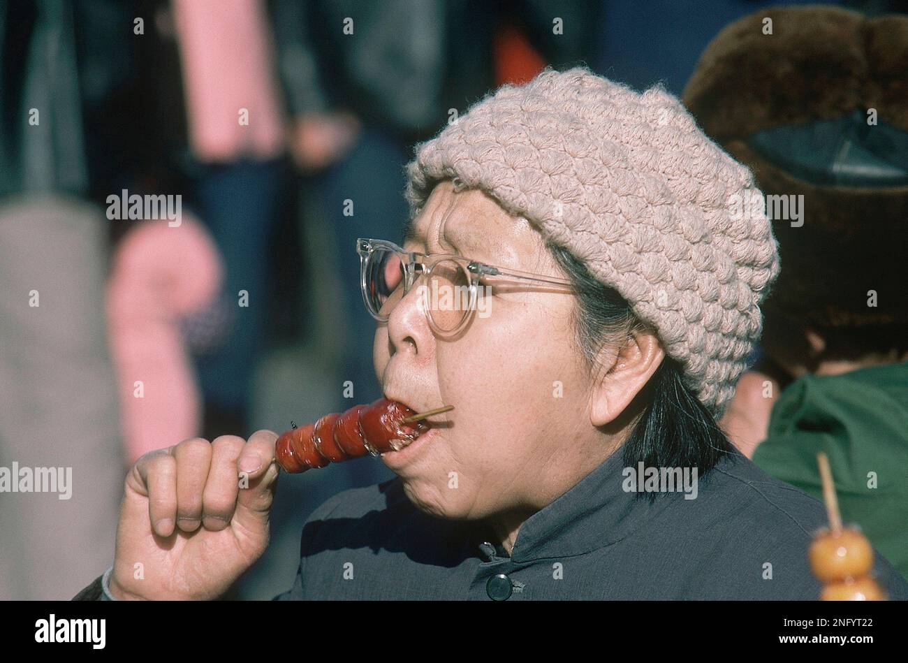 Seen here is a woman eating in one of Beijing's main shopping street ...