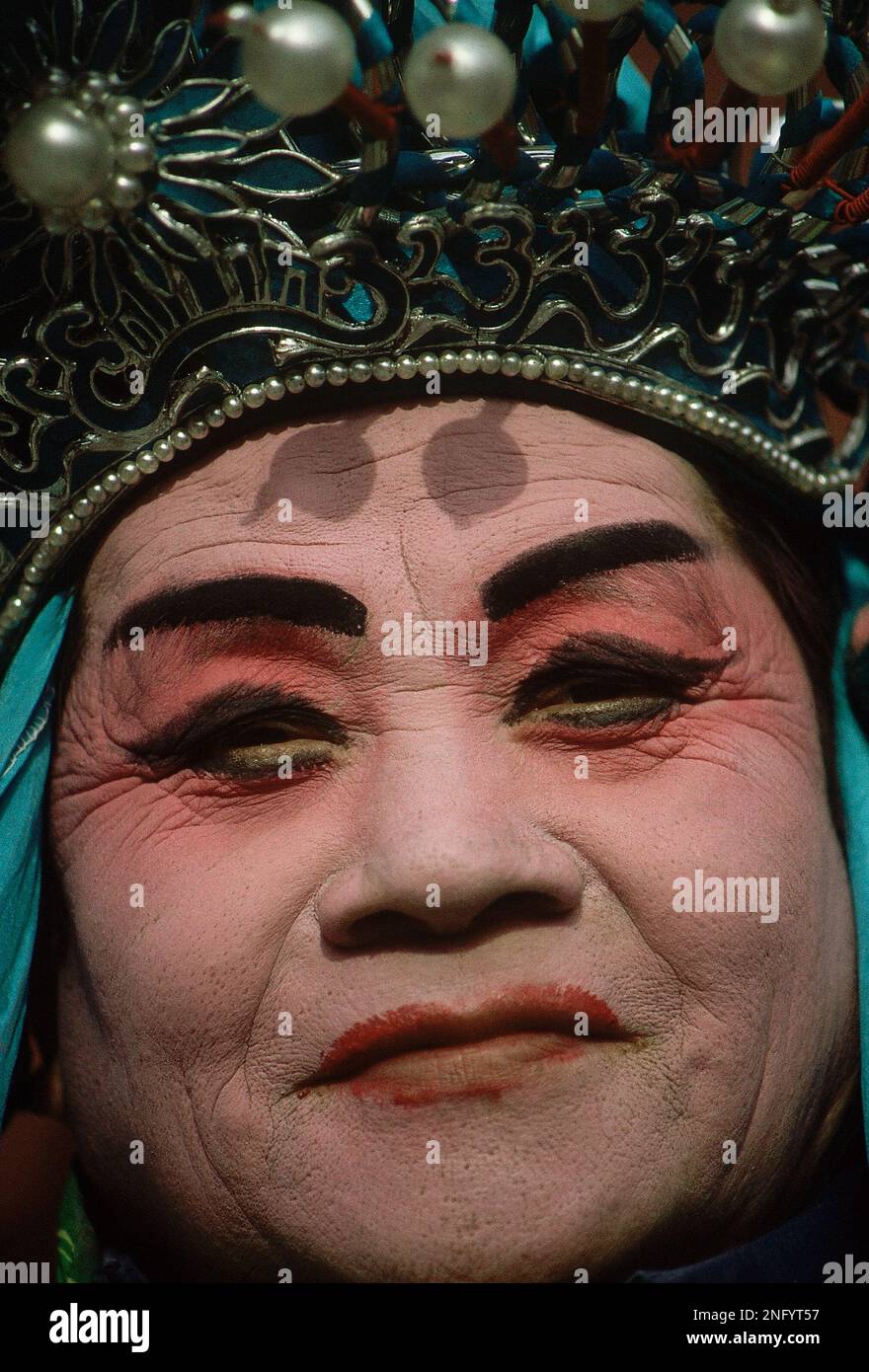Seen here is a performer from the Chinese Opera in makeup before a ...