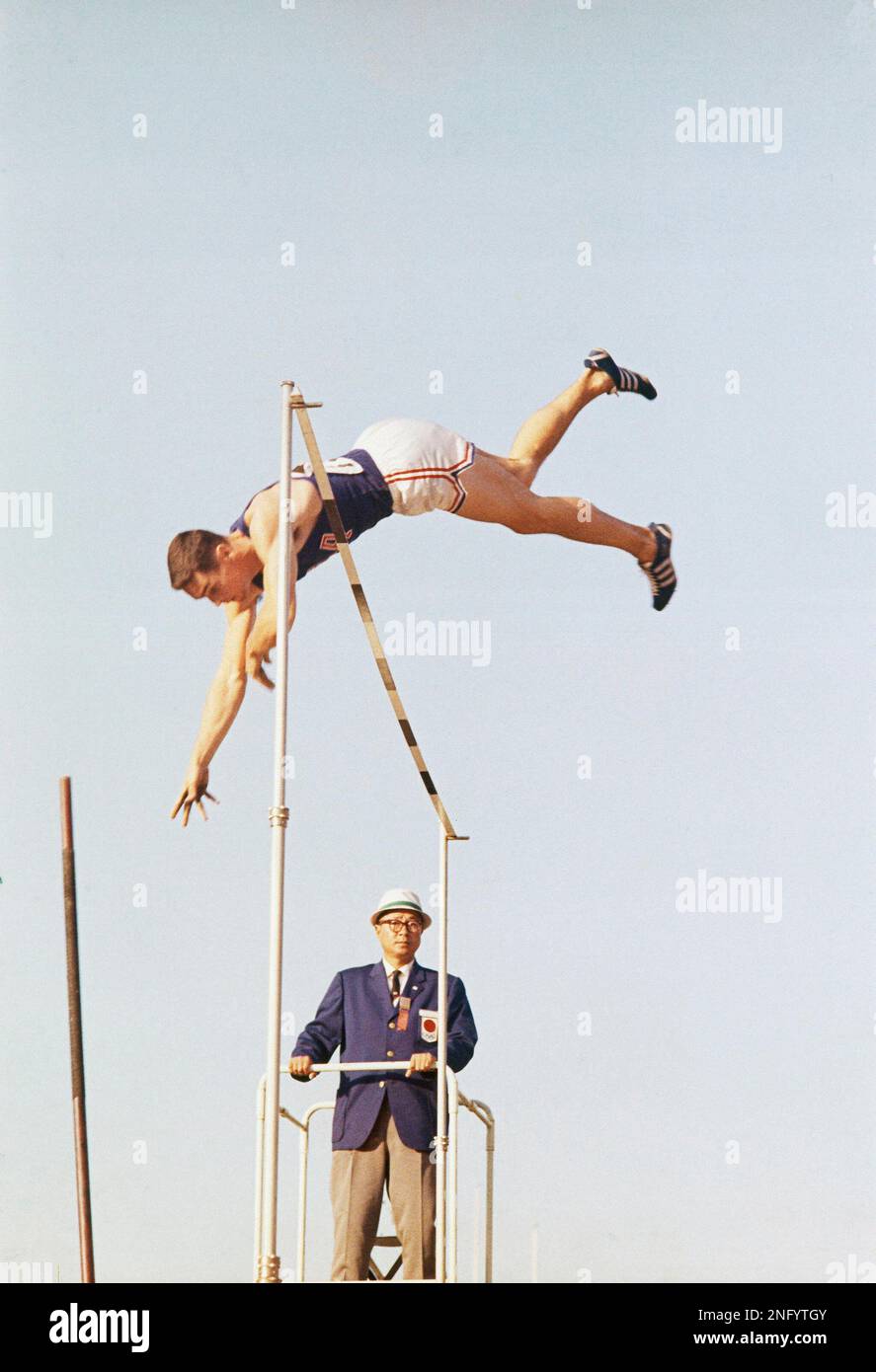 Unidentified pole vaulter #73 clears the bar at the 1964 Tokyo Olympics ...