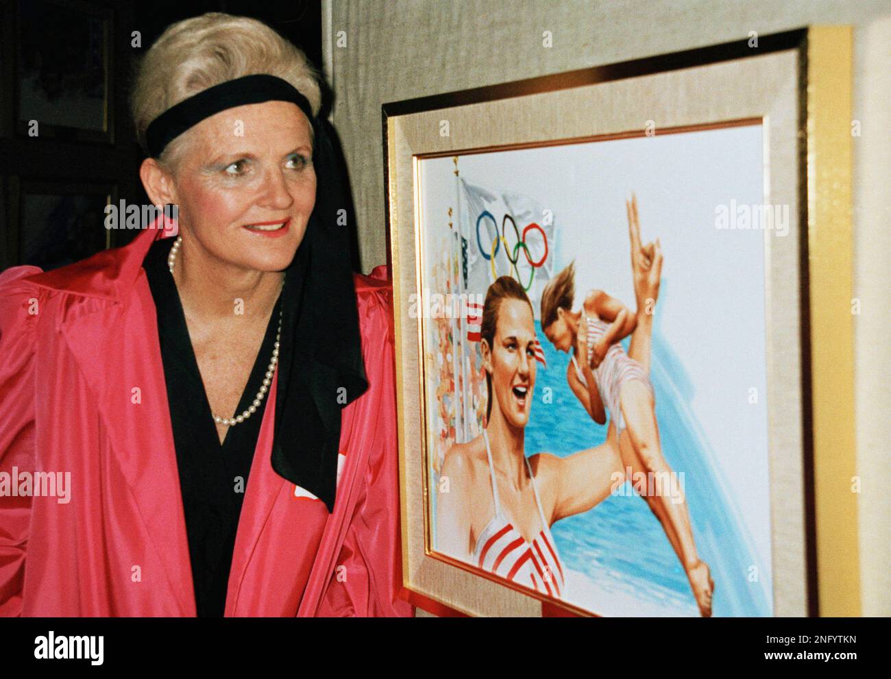 Pat McCormick stands in front of artwork at the Olympic Hall of Fame in ...