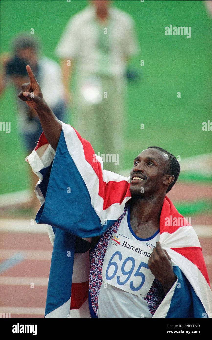 Britain's Linford Christie, wrapped in the Union Jack, celebrates after ...