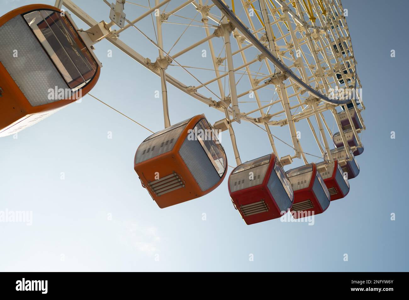 Colorful passenger cabins on modern Ferris wheel against blue sky Stock ...