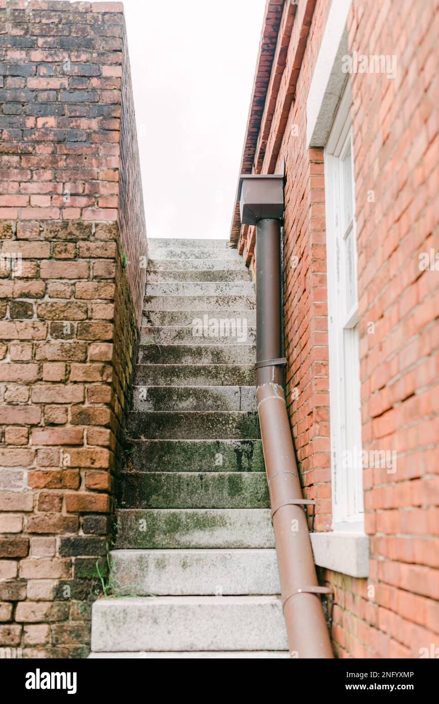 A vertical shot of old stone stairs between stone walls of houses Stock ...