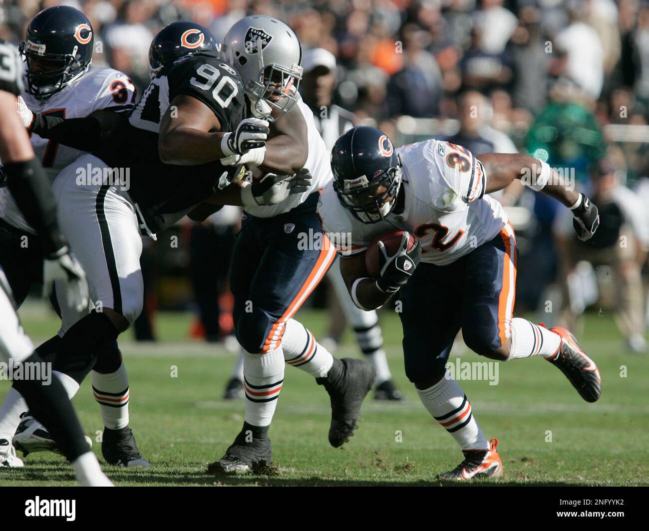 Chicago Bears running back Cedric Benson (32), right, carries the ball ...