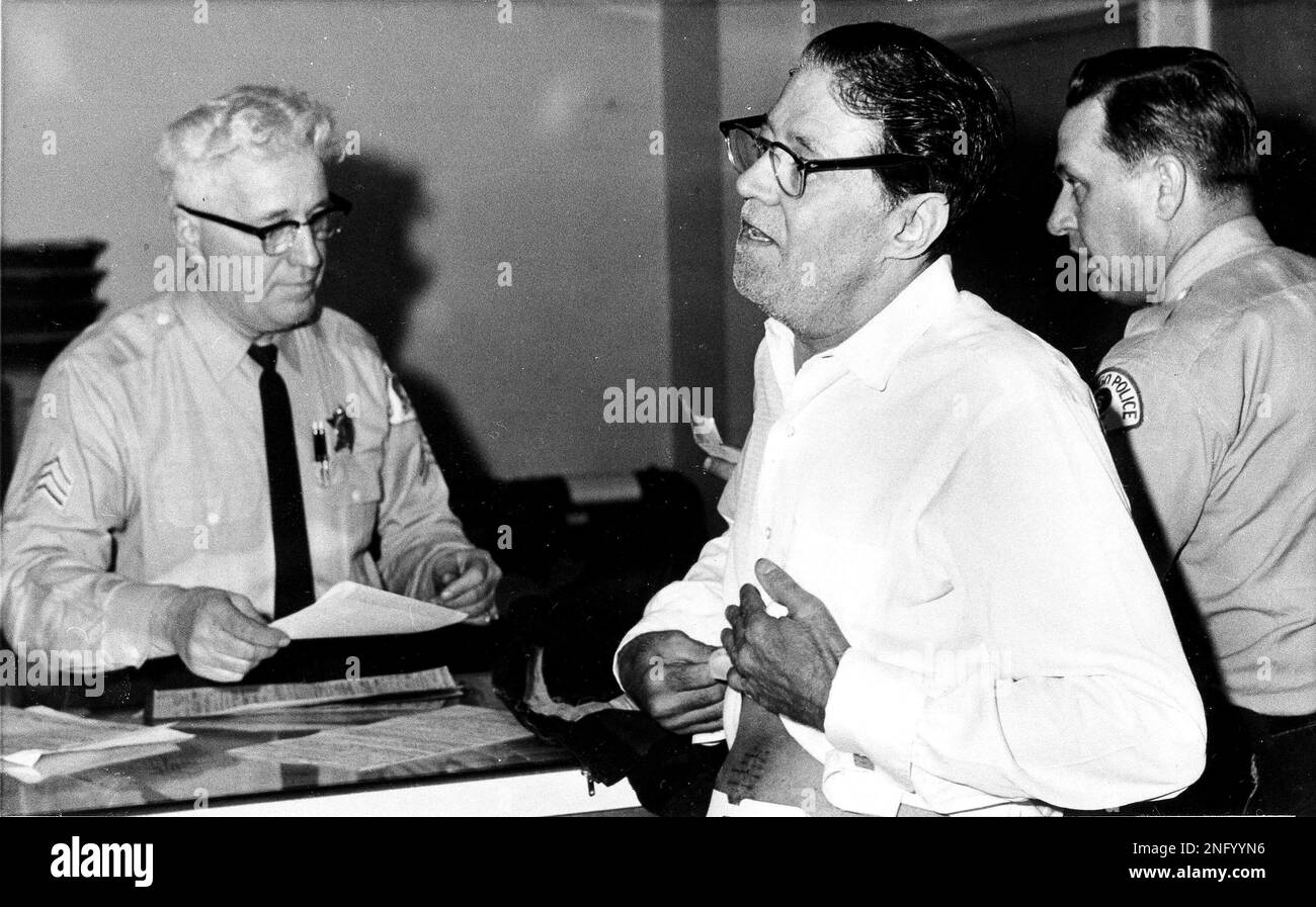 Sam DeStefano one of the seven arrested by police opens his shirt to ...