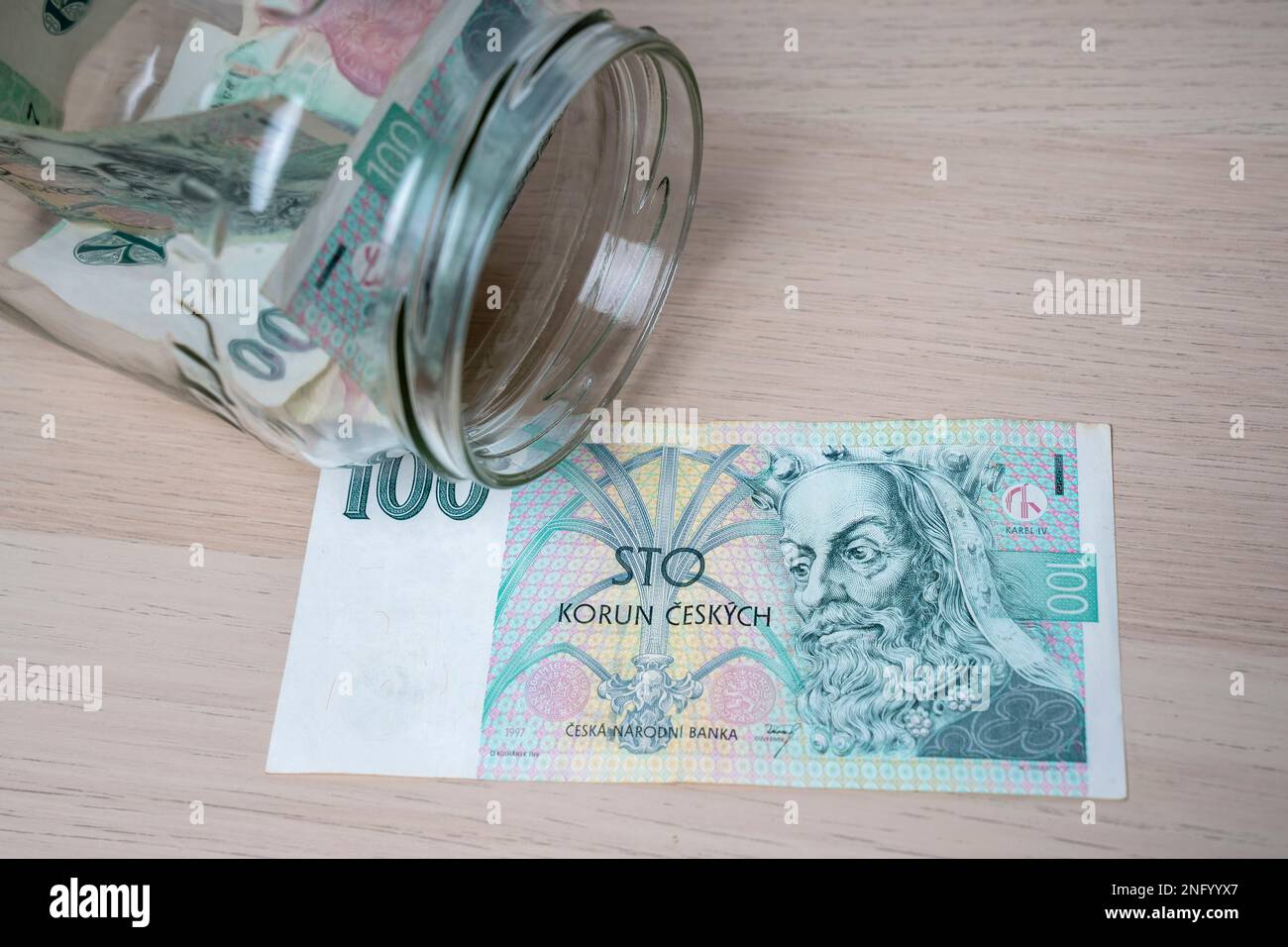 100 korun banknote of the Czech Republic banknotes in the glass jar ...